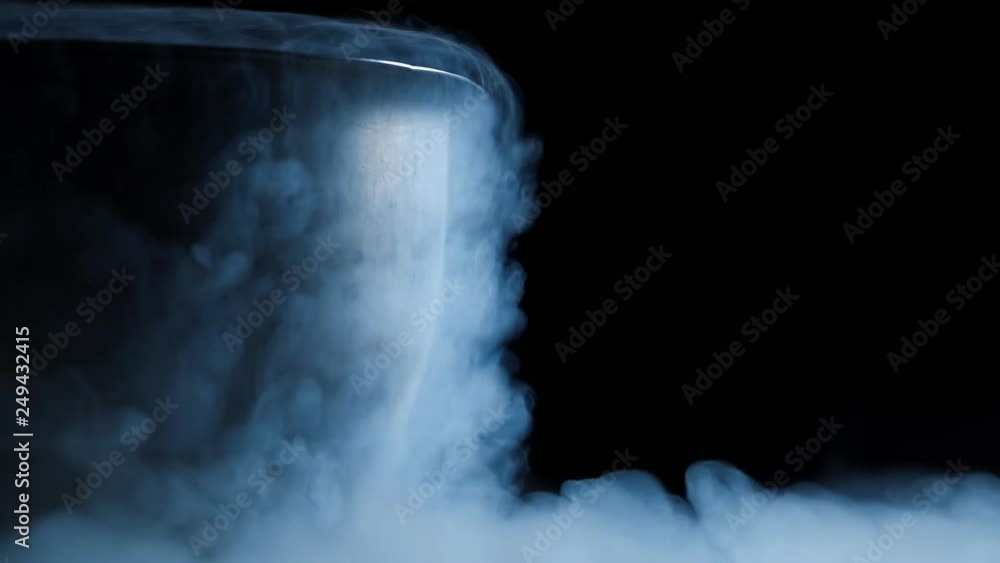 Wideo Stock: Vapor from liquid nitrogen from metal bowl creeps along ...