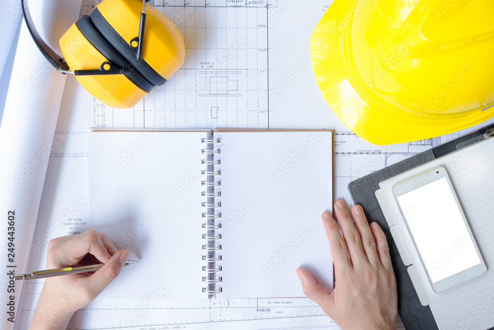 Desk of engineer design works office in plants with safety equipment ...