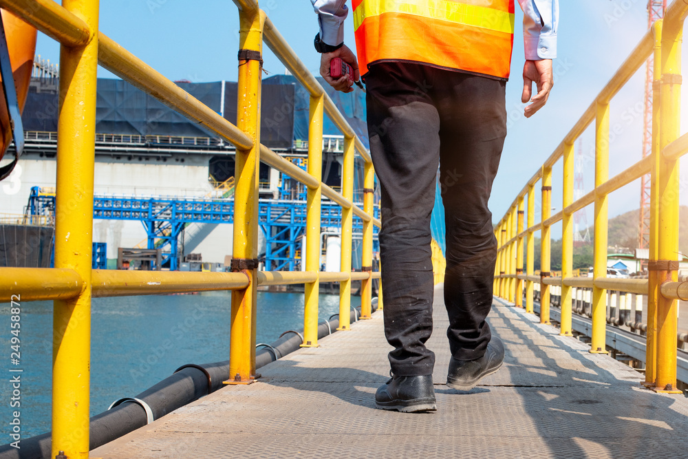 Safety shoe of worker walking in mind step on the steel checker plate ...
