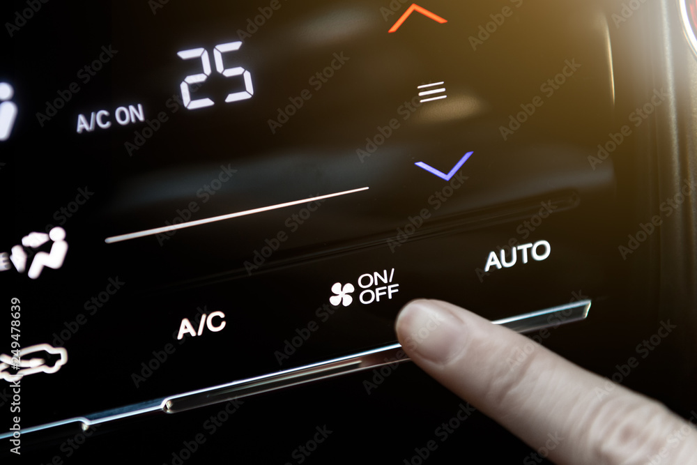 finger woman car driver push on or off air condition button while ...