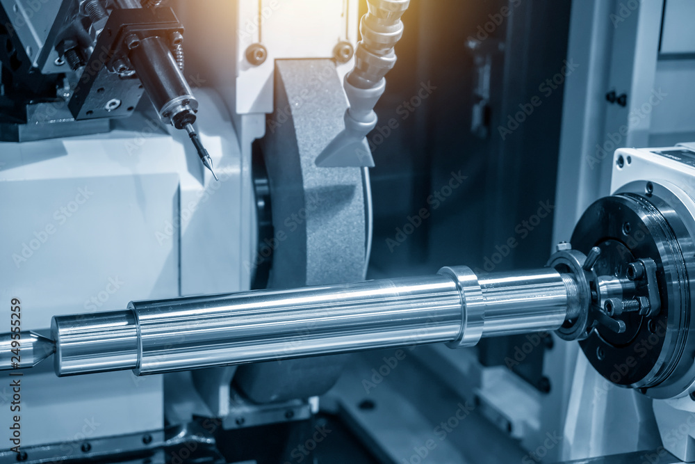The metal shaft on the cylindrical grinding machine.The automotive part ...