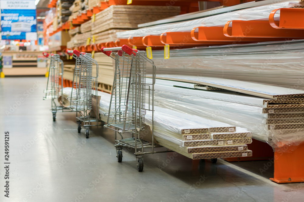 construction cart in the building store. Carts loaded with boards. shop ...