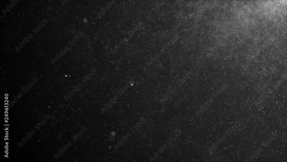 Natural organic dust particles floating on a black background ...