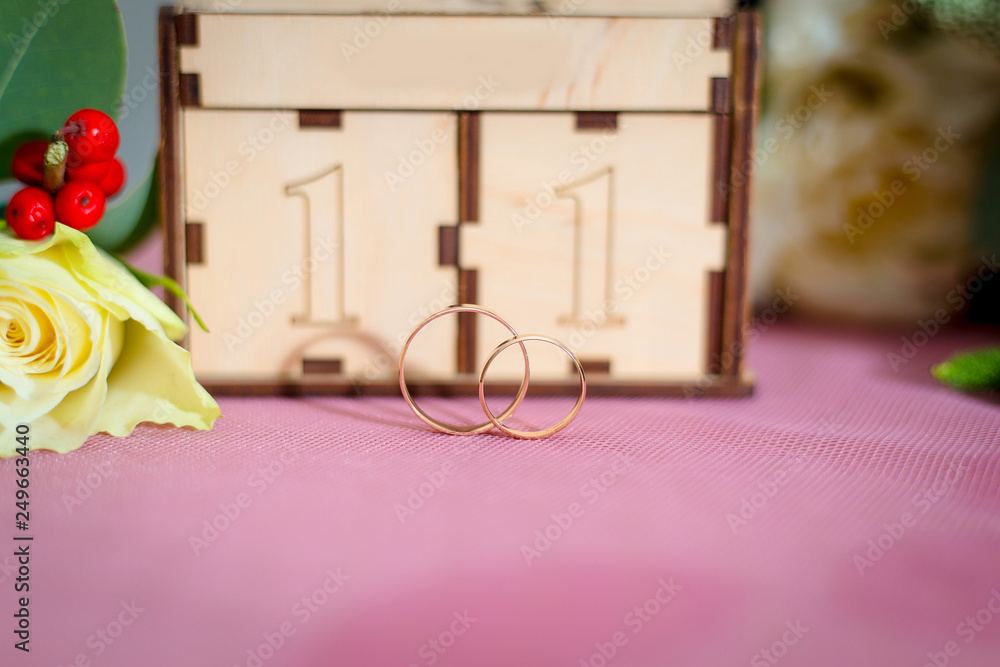 Two wedding rings as a symbol of infinity on the background of a wooden ...