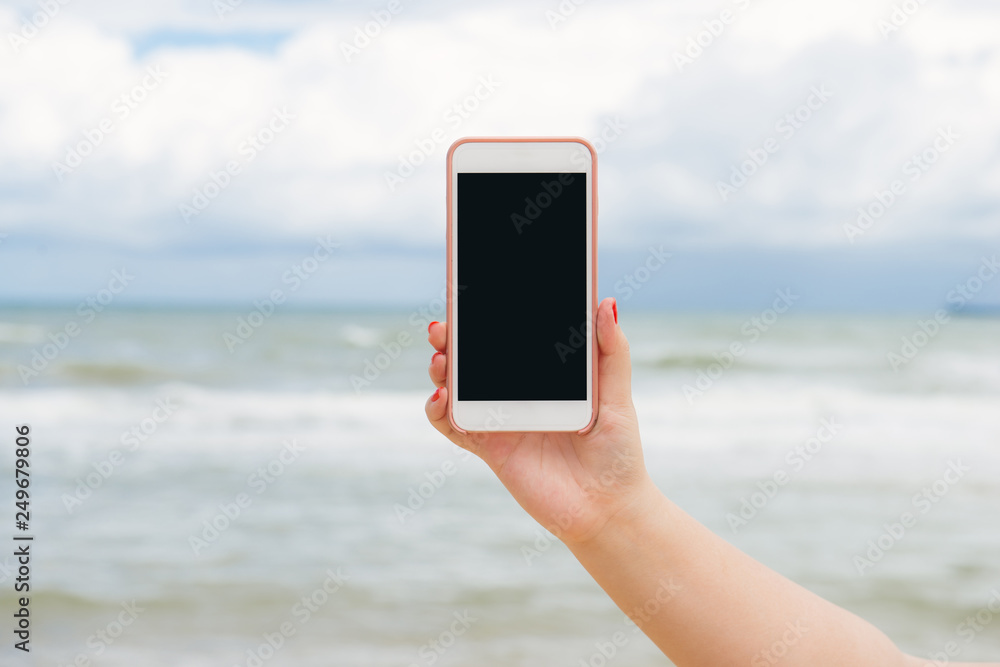 Hand holding phone at sea , mobile template for text in side Stock ...