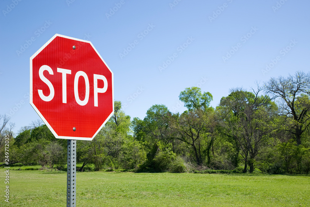 Stop Sign With Green Field And Trees Stock Photo | Adobe Stock