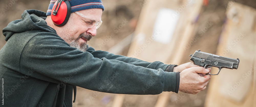 Shooter holding gun and training tactical shooting. Close-up detail ...