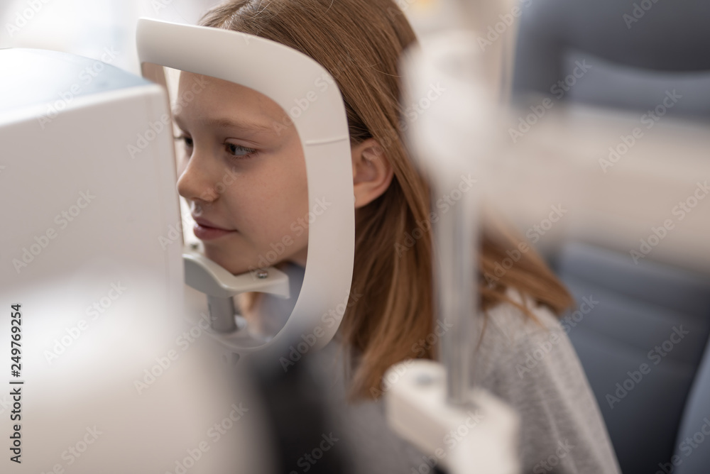 Cute little girl having eye examination at modern clinic Stock Photo ...