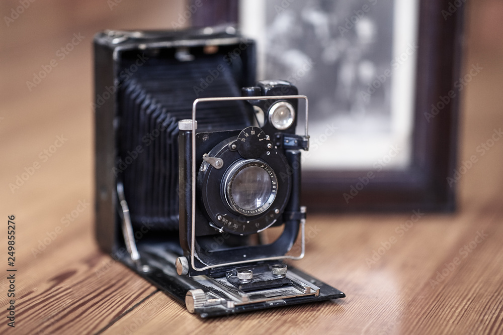 Close up image of old vintage dusty camera with old picture on blurred ...