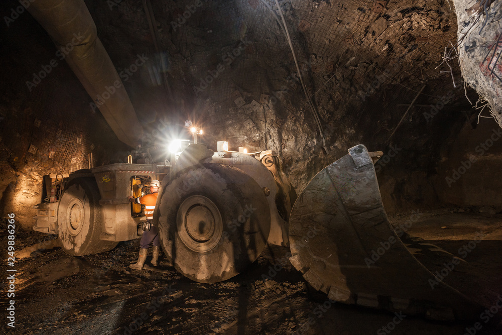 Miner with a large truck known as a 'bogger' underground at a copper ...