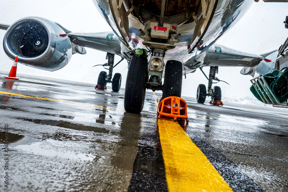 Passenger aircraft on maintenance and flight preparation. View under ...