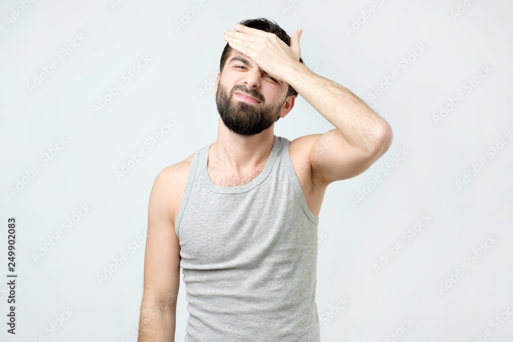 Spanish man putting his hand on the forehead remembering something ...