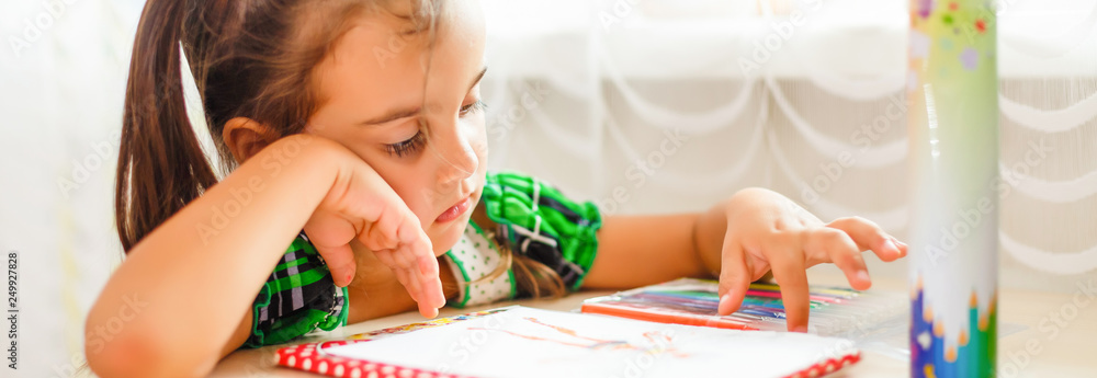 Girl doing homework. The child was tired of congestion at the school ...