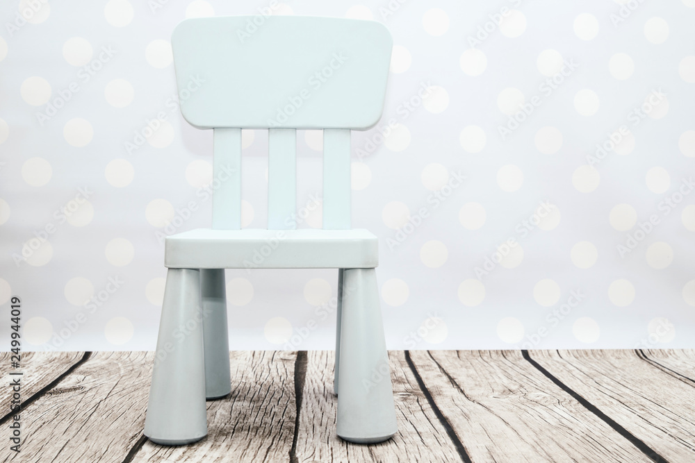 Blue pastel chair on a pastel background side view. Pastel colors. Baby ...