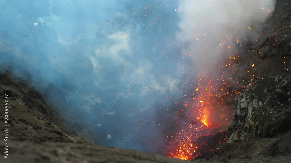 CLOSE UP: Roaring active volcano blasting out the glowing lava out of ...