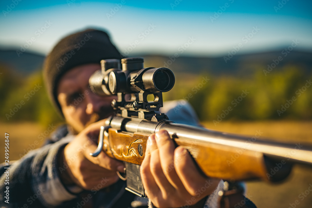 Hunter with Powerful Rifle with Scope Spotting Animals. Hunter with ...