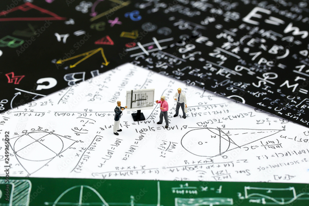 Miniature people : teacher and friend with Math problems on graph paper ...