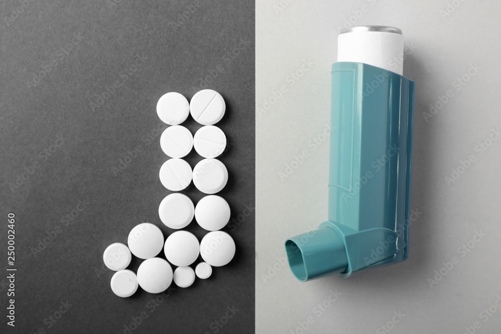Inhaler and pills on color background Stock Photo | Adobe Stock