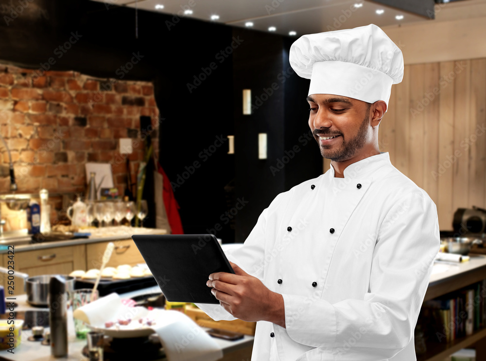 cooking, profession and people concept - happy male indian chef in ...