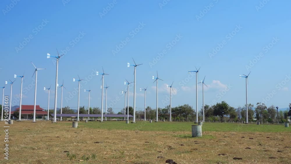 Wind turbines farm eco field in bright day with blue sky background at ...