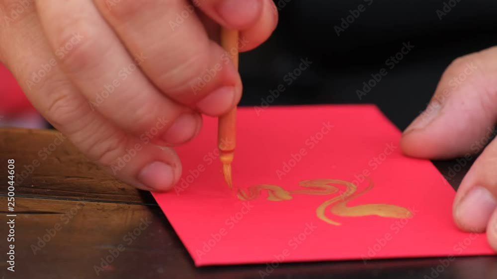 Video Stock Vietnamese scholar writing calligraphy on red envelope, ang ...