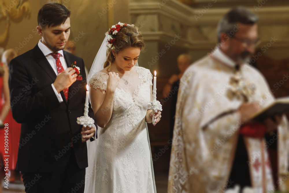 Spiritual couple, bride and groom holding candles during wedding ...