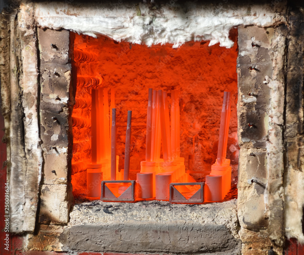 Red hot parts in an electric furnace for hardening metal. Hardening of ...