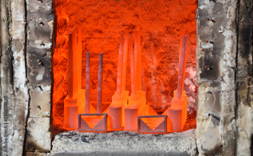 Red hot parts in an electric furnace for hardening metal. Hardening of ...