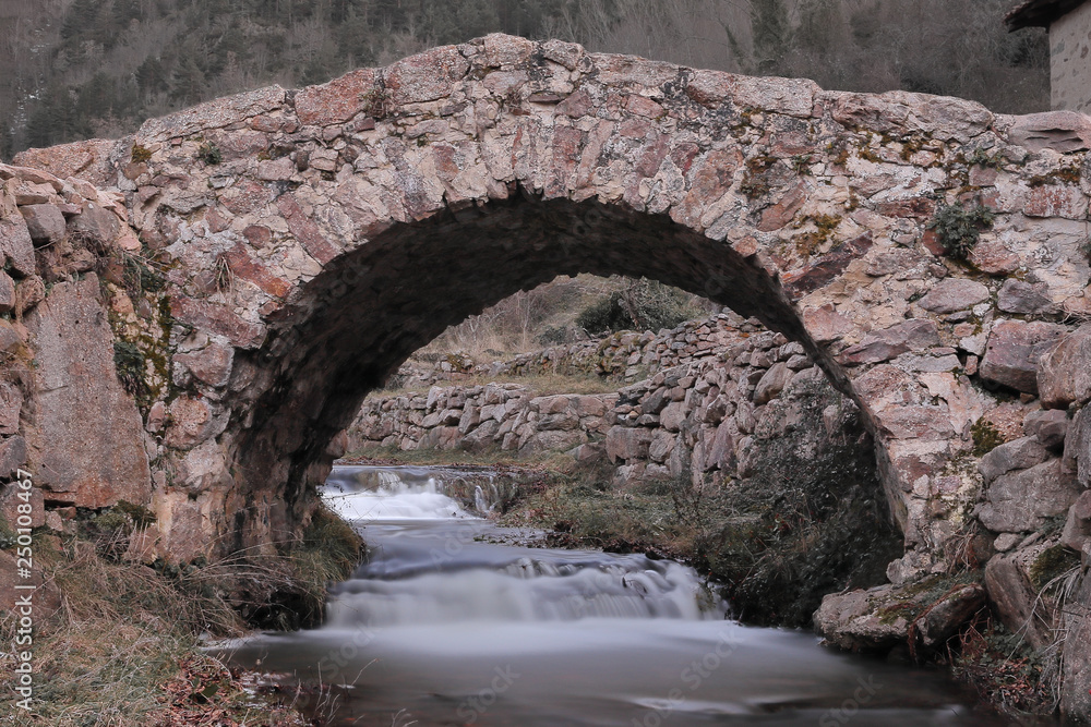 MEDIEVAL BRIDGE WITH ROUND ARCH OF THE 16TH CENTURY ON THE CREEK OF THE ...