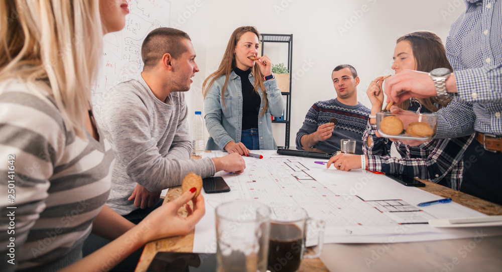 A group of young entrepreneurs discussing their next project at a ...