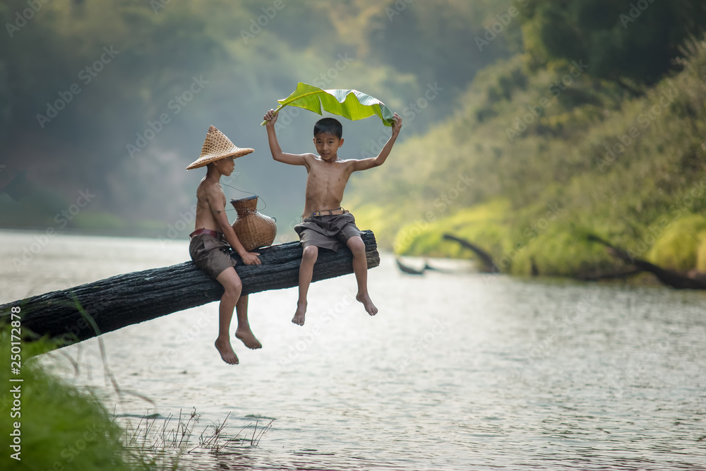 Children poverty living in countryside Vietnam are fishing at the river ...