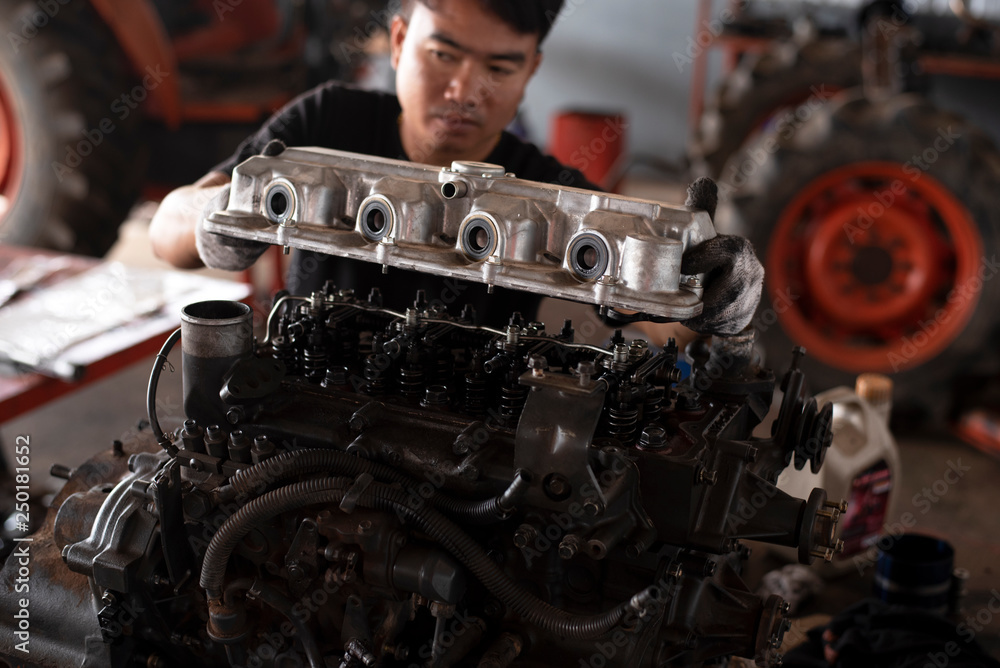 The car mechanic is working with the car engine in the garage ...