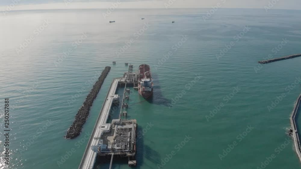 Aerial view of an oil jetty with a tanker. Stock Video | Adobe Stock