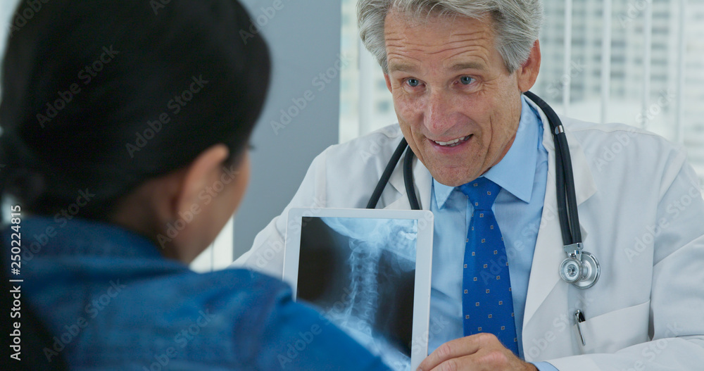 Happy doctor smiling and laughing with patient while talking about ...