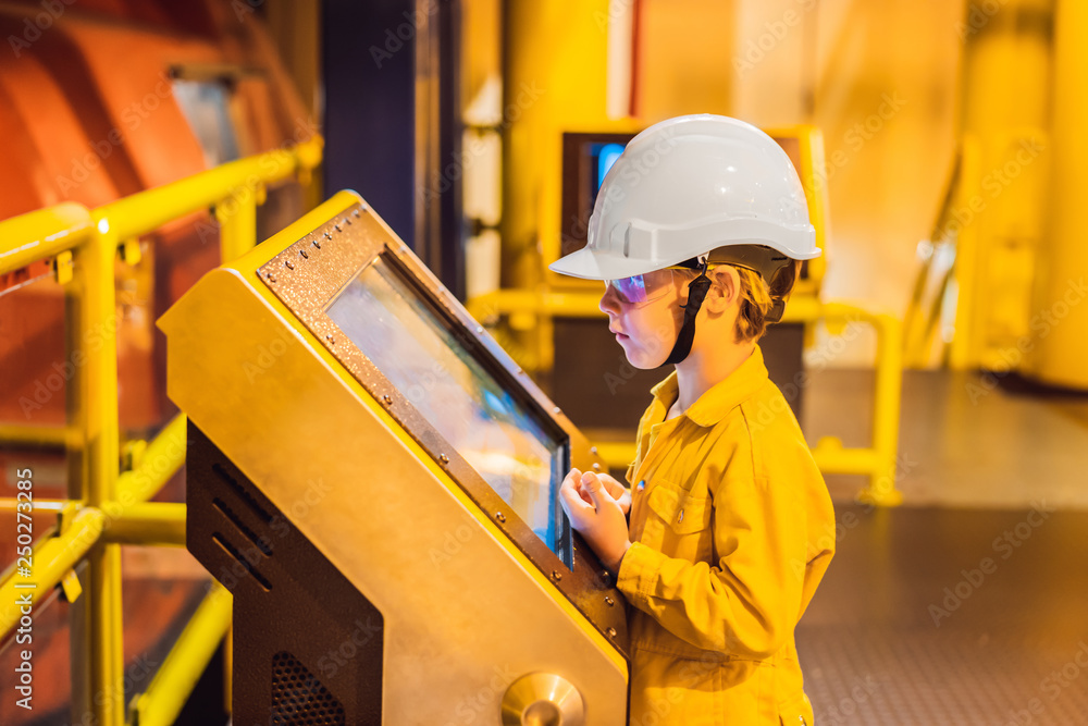 Boy operator recording operation of oil and gas process at oil and rig ...