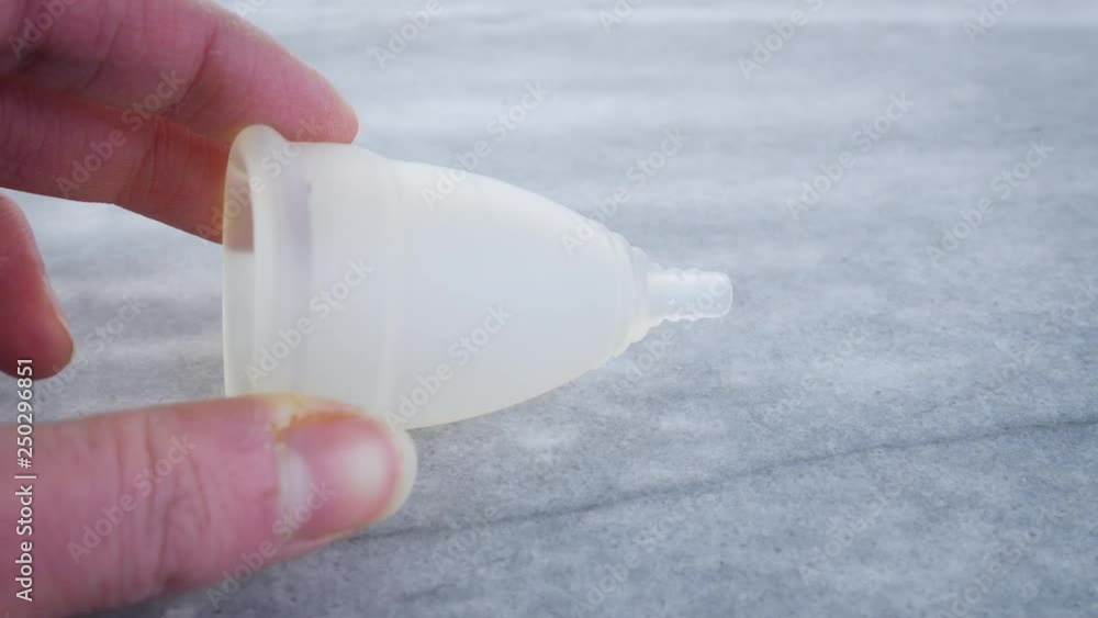 Replacing tampons with a silicone diva cup and copy space for text ...