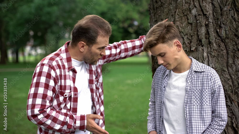 Dad scolding his son for bad behavior, education process, fathers and ...