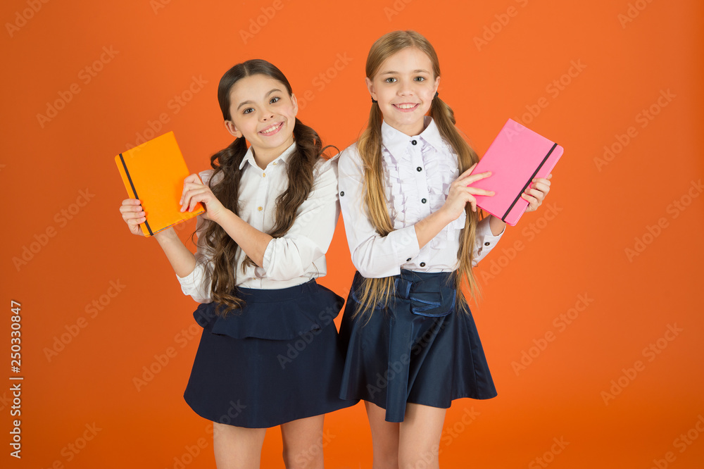 Girls cute kids school uniform orange background. Schoolgirl show book ...