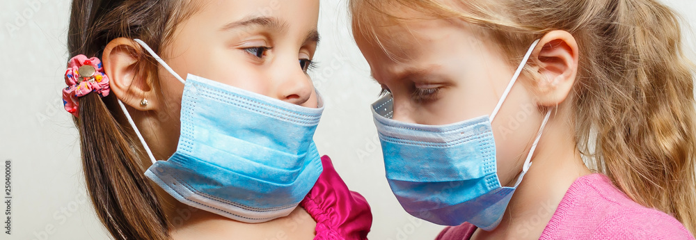 Sick child girls at home. two Kids are wearing breath mask for protect ...
