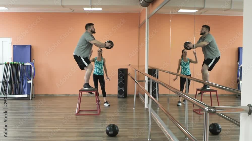 Overweight male and female trainer with perfect body burn calories by ...