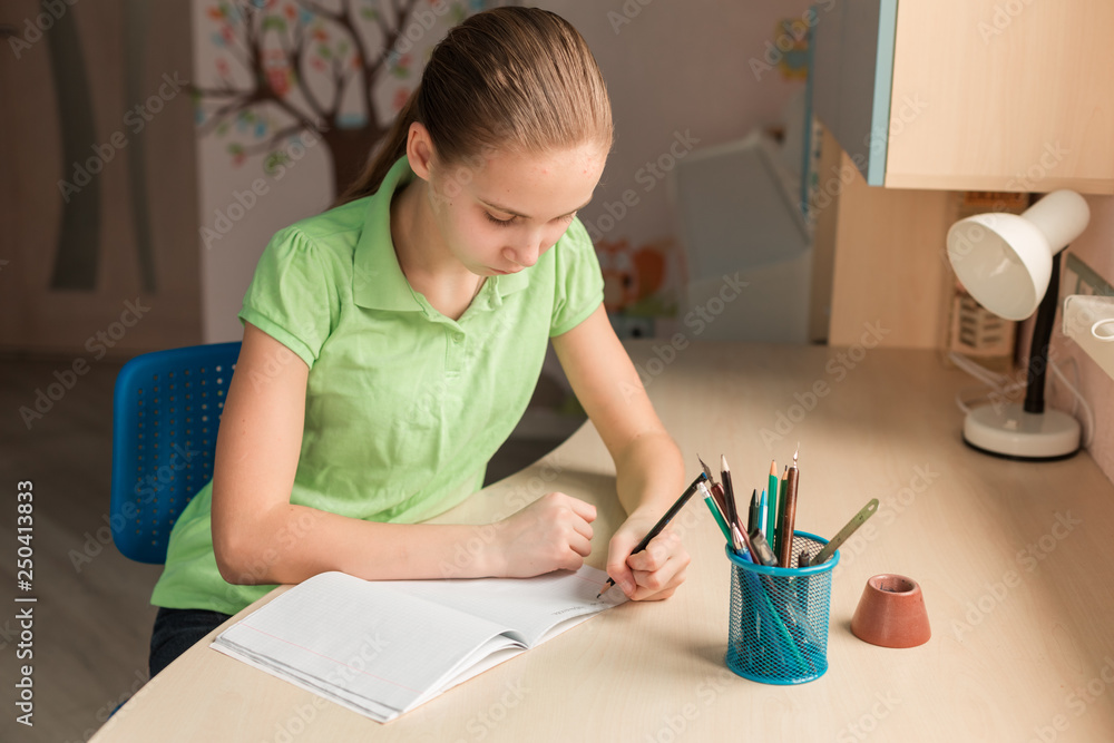 Cute little girl left-handed writing her homework Stock Photo | Adobe Stock