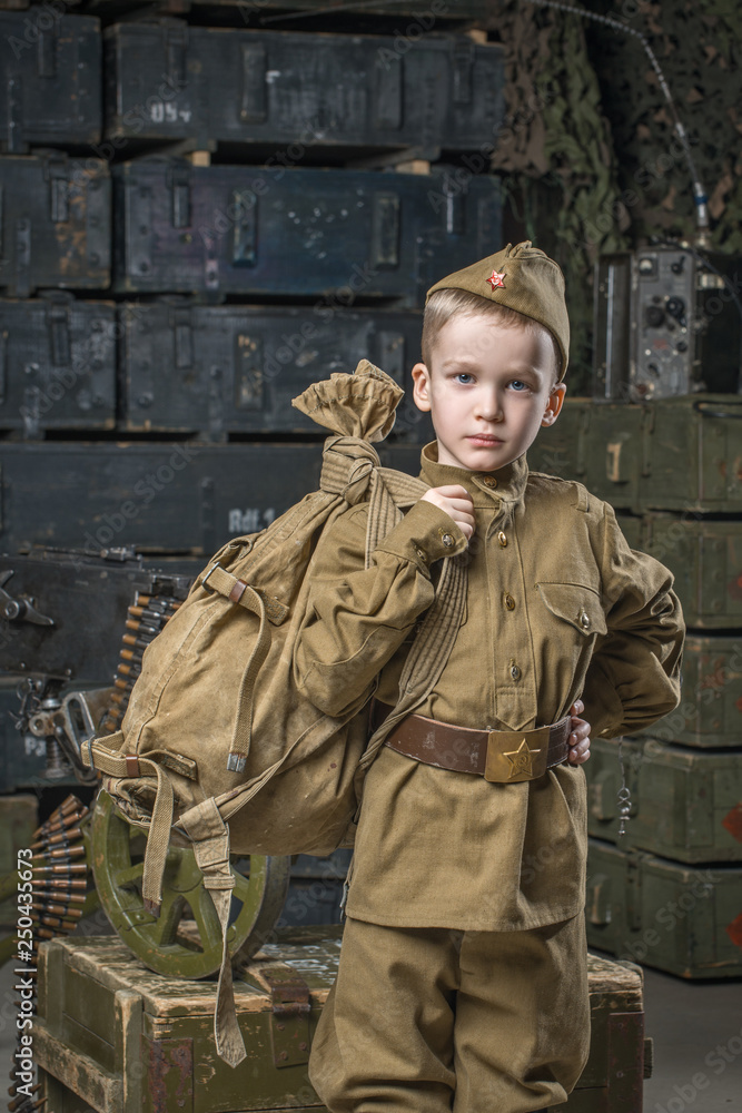 The boy is dressed in military uniform Stock Photo | Adobe Stock