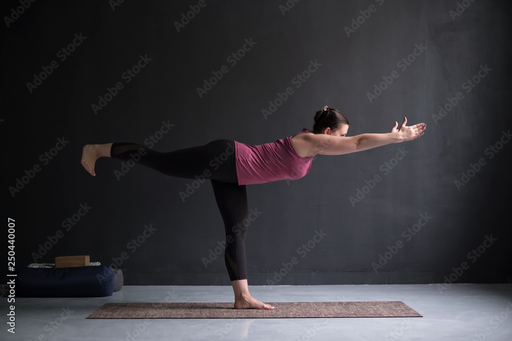 woman practicing yoga, doing Warrior III exercise, Virabhadrasana 3 ...