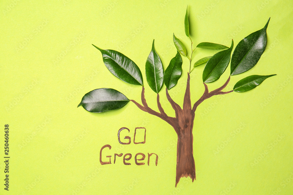 Drawn tree with fresh leaves and text GO GREEN on color background ...