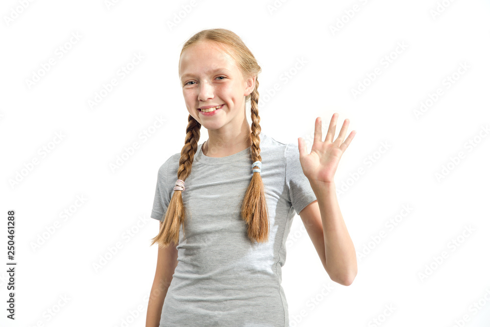 Hello! Teen girl waving her hand in greeting. Stock Photo | Adobe Stock