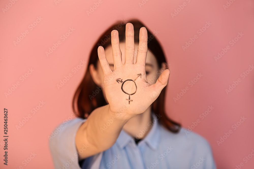 Woman with drawn symbol of transgender on her palm against color ...