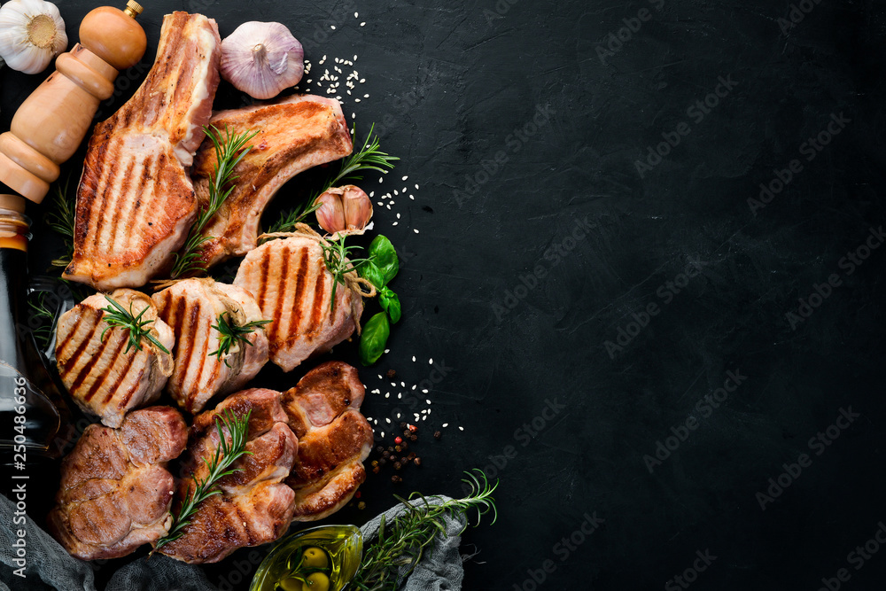 Grilled Meat. Seth meat. Grill, barbecue. On a black stone background ...