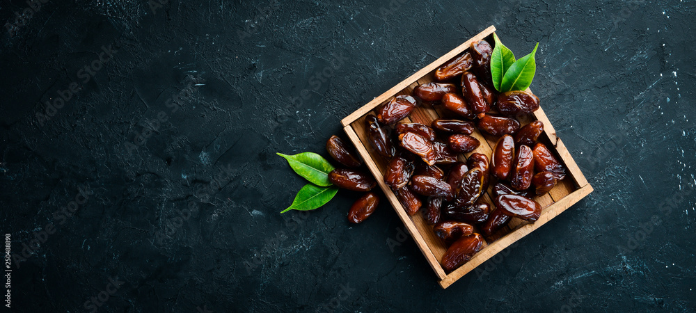 Dry date on a black background. Top view. Free space for your text ...