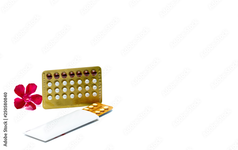 Contraceptive pills or birth control pills with pink flower on white ...