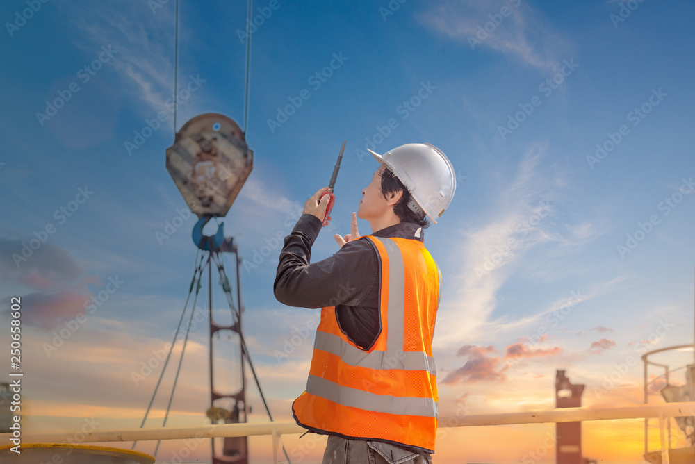stevedore, foreman or engineering, loading master connecting to crane ...